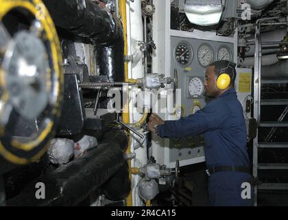 US Navy Engineman 3rd Class autographs a soccer ball at the Iram ...