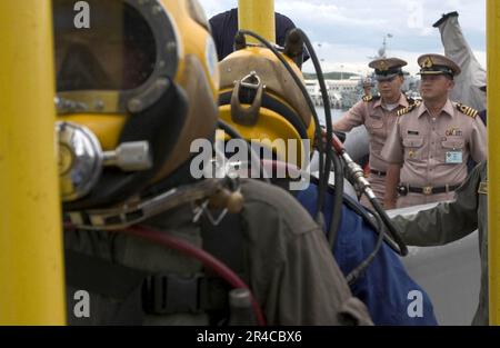 US Navy A U.S. Navy diver is lowered into the water during a series of training dives during a ...