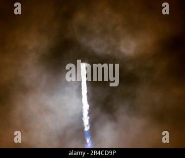 A SpaceX Falcon 9 rocket passes through a vapor plume as it goes ...
