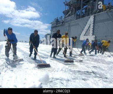 US Navy Sailors conduct a scrubbing exercise on the flight deck aboard ...