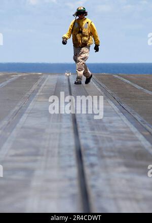 US Navy Catapult shooter, Lt. gives the launch signal to an aircraft as ...