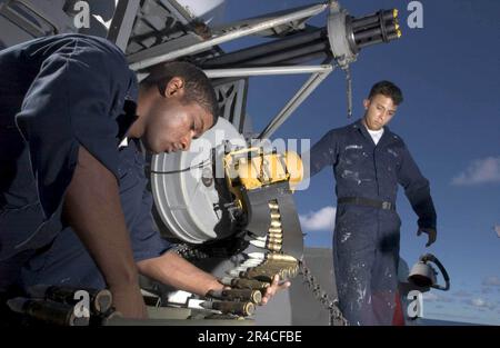 US Navy Fire Controlman 3rd Class left, is assisted by Aviation ...