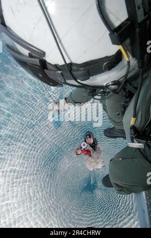 US Navy EOD team member dives into the water for an inspection of the ...
