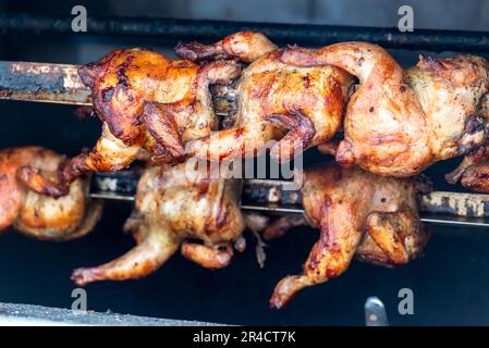 Rotating machine are grilled whole chicken. Roasted chickens in a row ...