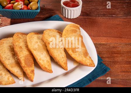 Fried Pastries, Pastel Frito Brasileiro, on wooden table. Pastel de ...
