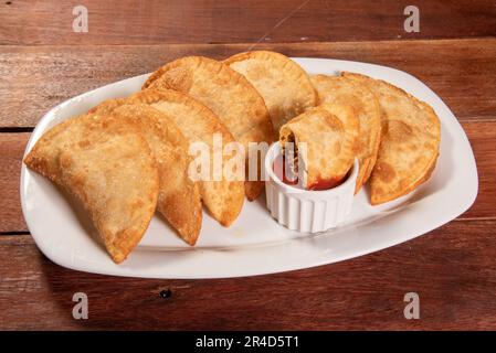 Fried Pastries, Pastel Frito Brasileiro, on wooden table. Pastel de ...