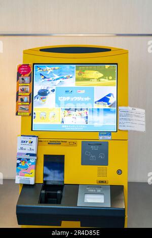 Close up of a Japanese Oki yellow boarding pass automatic machine with ...