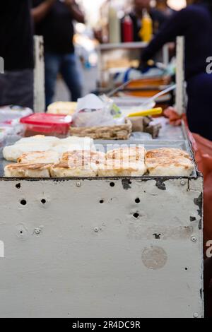 Ham and cheese arepas on a griddle in Cartagena Colombia Stock Photo ...