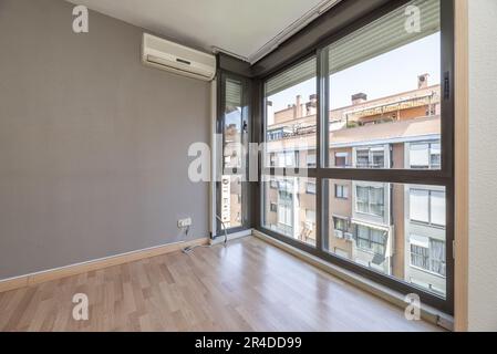 Corner of a room with sliding aluminum windows, air conditioner unit ...