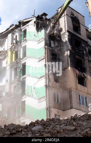 Excavator with hydraulic crusher at the demolition of a residential ...