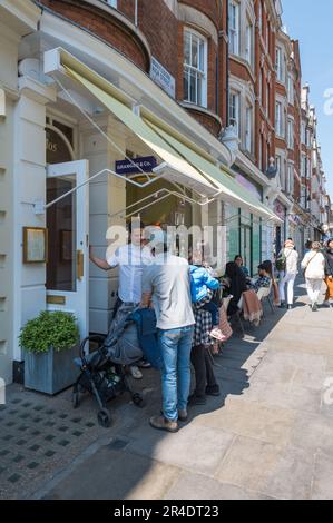 Waiter greets customers at the entrance to Granger & Co. restaurant on ...