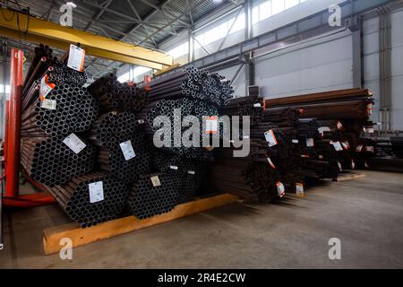 Pipes and tubes warehouse in hangar Stock Photo - Alamy