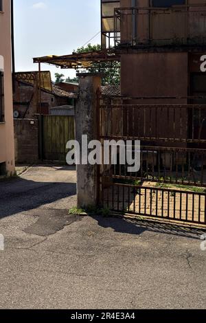 Abandoned warehouse blocked by gates in an alley on a sunny day in the ...