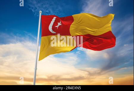 official flag of Selangor Malaysia at cloudy sky background on sunset ...