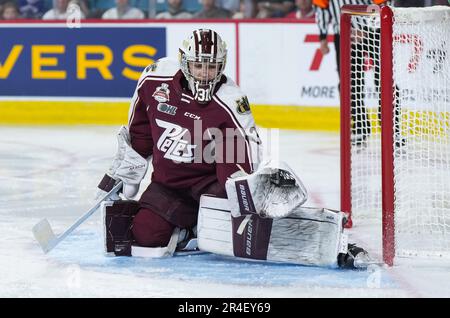 Peterborough Petes goalie Michael Simpson, center, stops a shot from ...