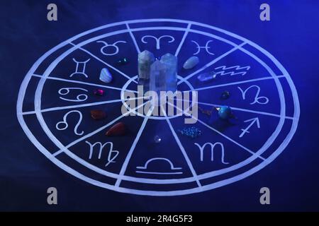 Natural stones for zodiac signs, drawn astrology chart and burning ...