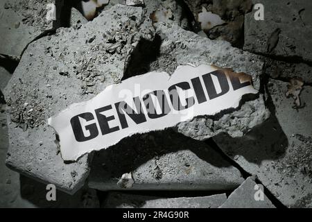 Paper with word Genocide on pieces of concrete, top view Stock Photo ...