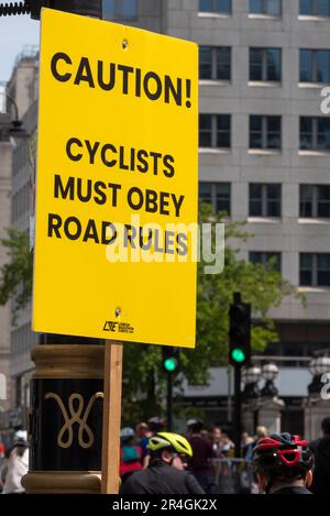 Caution, cyclists must obey road rules sign at the 2023 Ford RideLondon ...