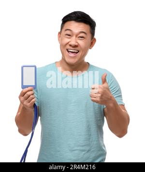 Happy asian man with vip pass badge showing thumbs up on white ...