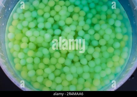 Large bucket full of green boba balls in liquid Stock Photo - Alamy