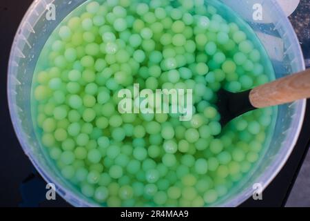 Large bucket full of green boba balls in liquid Stock Photo - Alamy