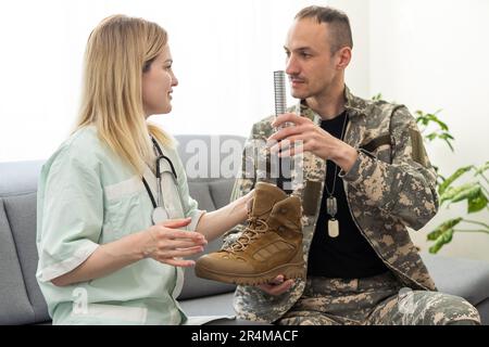 A female prosthetist wraps a plaster cast around the leg stump ...