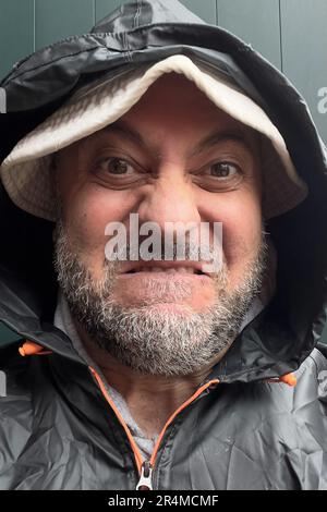 Portrait of angry fisherman Stock Photo - Alamy