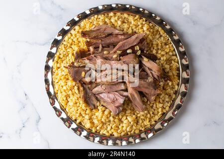 Turkish foods; lamb shank tandoori on bulgur wheat rice (Turkish name ...