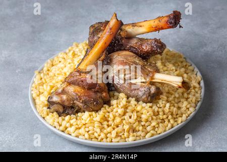 Turkish foods; lamb shank tandoori on bulgur wheat rice (Turkish name ...