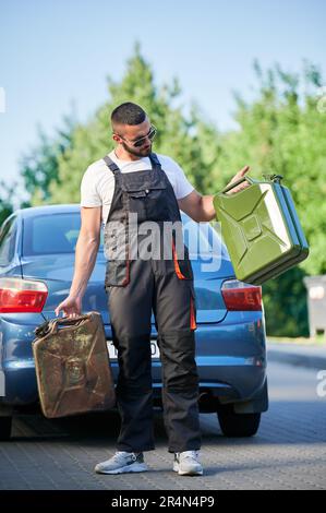 Young gas station operator waiting for new customers. Professional ...