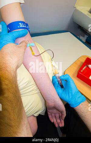 Blood test being performed on a middle aged man's arm by a Practice ...