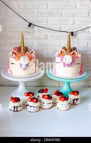 Macarons and berries on white table Stock Photo - Alamy