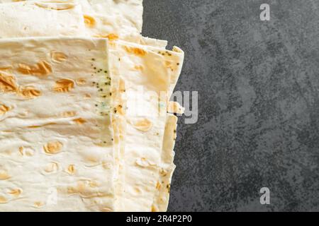 Spoiled pita, moldy. Mildew on the bread. Gray background. copy space ...