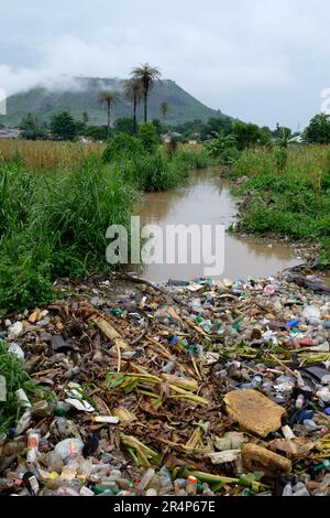 Garbage and discarded mixed plastics floating on a stream in Makeni ...