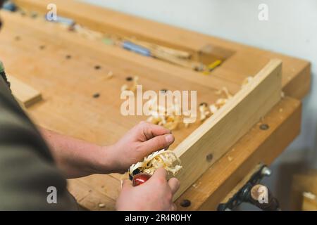 A closeup shot of a wooden jack-plane isolated on white background ...