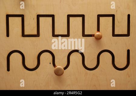 Wooden sliding maze with different lines on table. Montessori toy Stock ...