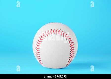 Baseball ball on light blue background, top view. Sports game Stock ...