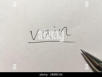 Vain concept word on paper background Stock Photo - Alamy