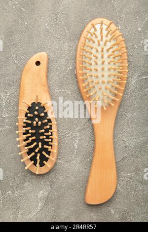 Set of comb and hairbrush on grey background. Top view Stock Photo - Alamy