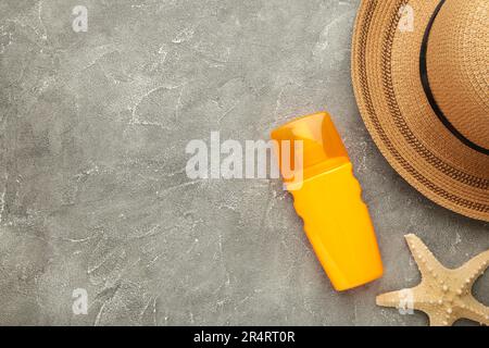 Sunscreen bottle with hat and shells on white background. Cosmetics for ...
