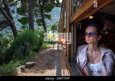 Tourists inside of tren de Soller train vintage historic train that ...