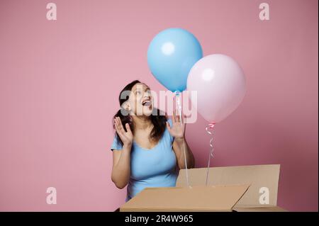 Pretty pregnant woman surprised by a gender reveal party, in ...