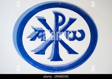 Blue painted Chi Rho symbol painted over ceramic surface. One of the ...