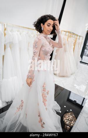 charming middle eastern bride with wavy hair in stunning wedding dress ...