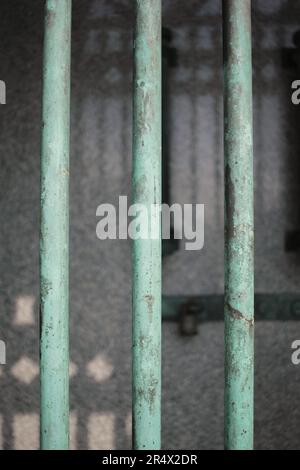 Vertical metal prison bars protecting the room inside Stock Photo - Alamy