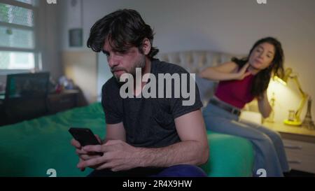 Disconnected couple Boyfriend looking at phone ignoring girlfriend by ...