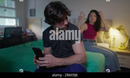 Disconnected couple Boyfriend looking at phone ignoring girlfriend by ...