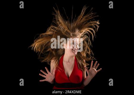 Young woman's hair flies dramatically up around her head; Lincoln ...