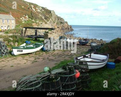 Old capstan boat winch with crab and lobster pots and fishing boats ...