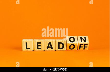 Lead on or off symbol. Businessman turns wooden cubes and changes word ...